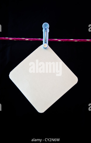 hang paper on black background Stock Photo - Alamy