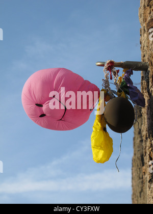 End of the party. Some burst, deflated balloons and one inflated ...