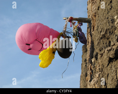 bunch of deflated balloons hanging from wall outdoors Stock Photo - Alamy