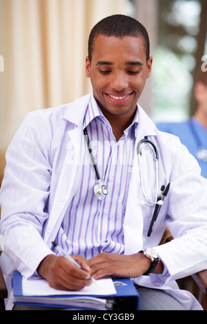 Portrait of African young IT specialist with folder smiling at camera ...