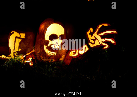 Halloween time. A skeleton crawling out of the grave and waving his ...