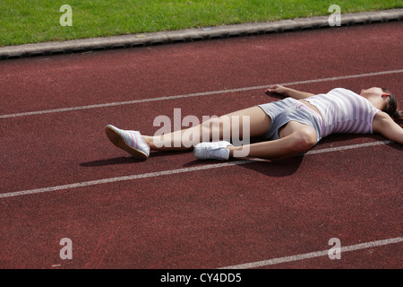 Woman has collapse and lies dead or unconscious after race on cinder ...