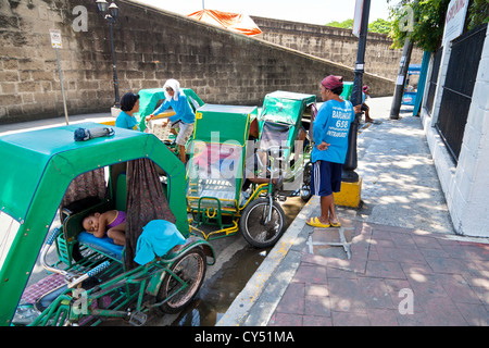 Topical green Rickshaws in the old Town of Manila, Philippines Stock ...