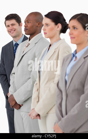 Smiling salesman standing next to his associates Stock Photo - Alamy