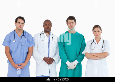 Serious looking medical team standing together Stock Photo - Alamy