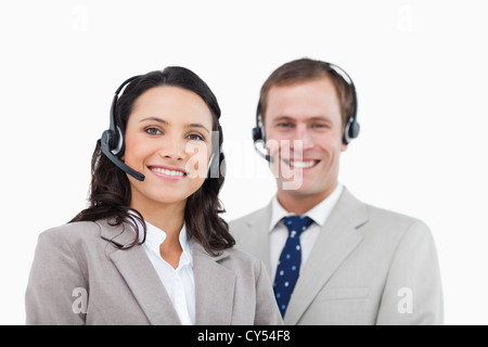 Smiling call center agents standing together against a white background ...