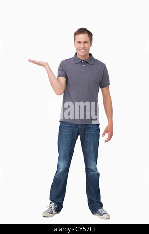 Happy smiling young man presenting Stock Photo - Alamy