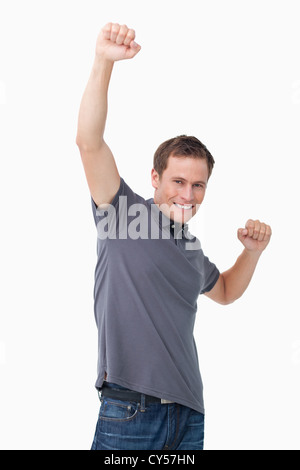 Victorious young man raising fist Stock Photo - Alamy