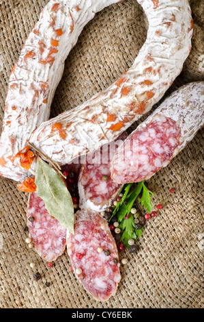 Salami sausage on a canvas Stock Photo - Alamy