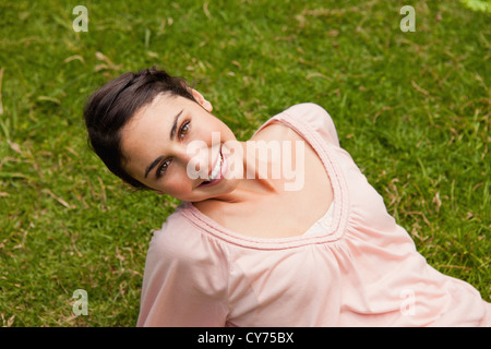 Smiling woman tilting her head while lying down Stock Photo - Alamy