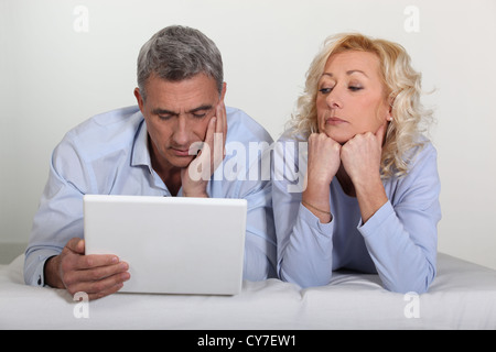 Portrait of bored unhappy couple looking at camera and wait. Clown ...