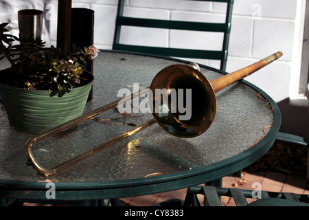 Trombone on glass table, outdoors Stock Photo - Alamy