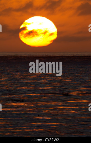 Large Sun Setting over the Pacific Ocean Stock Photo - Alamy
