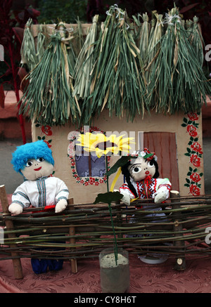 A Ukrainian woman in embroidered red national clothes holds an Easter ...