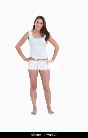 Relaxed young woman standing upright with arms by side Stock Photo - Alamy