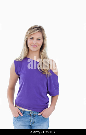 Smiling blonde woman placing her hands on her hips Stock Photo - Alamy