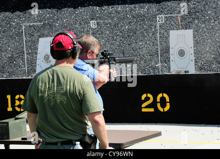 Gunman test firing automatic rifle at the FBI shooting range in Stock ...