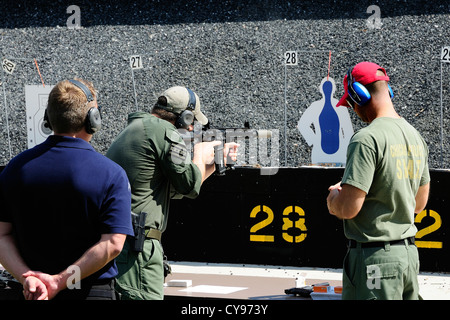 Gunman test firing automatic rifle at the FBI shooting range in Stock ...