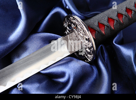 close-up of Japanese katana sword on blue satin background Stock Photo ...
