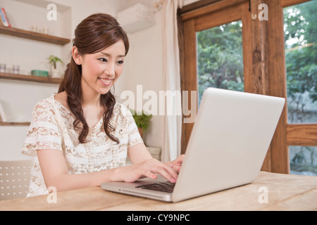 Young woman using laptop Stock Photo - Alamy