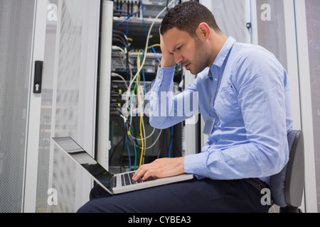 Technician becoming stressed over servers Stock Photo - Alamy