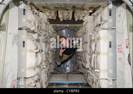 STS-135 Sandy Magnus floats freely in the Raffaello MPLM Stock Photo ...