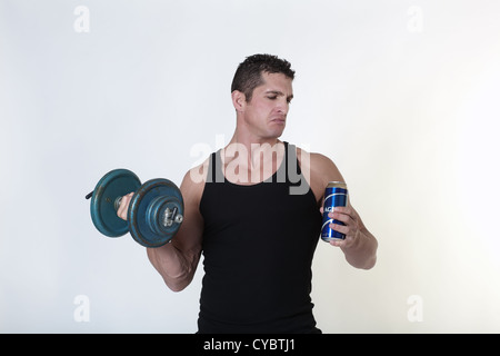 male bodybuilder not sure if he should have a drink of beer or carry on ...