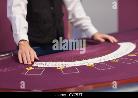Man dealing out cards in a casino Stock Photo - Alamy