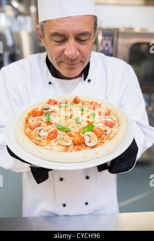 Chef smelling pizza Stock Photo - Alamy