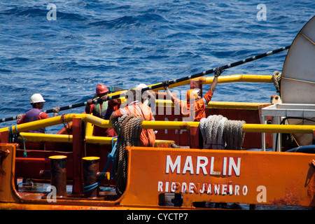 workers spooling a Seismic cable on deck of the supply vessel Marlin ...