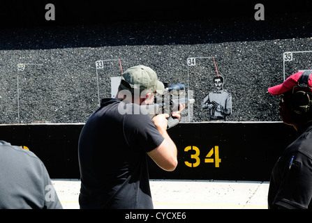 Gunman test firing automatic rifle at the FBI shooting range in Stock ...