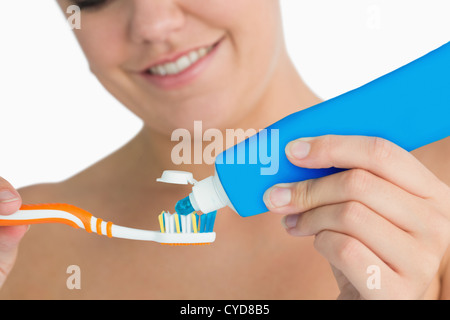 Toothbrush while putting on the toothpaste isolated on white Stock ...