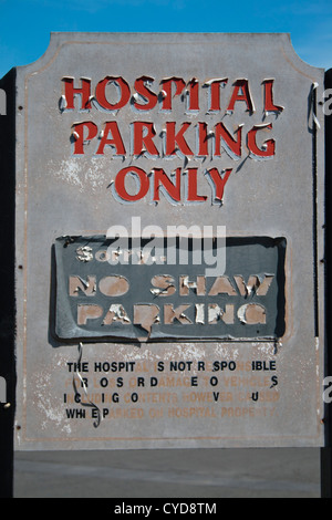 decrepit hospital parking only sign with peeling letters Stock Photo ...