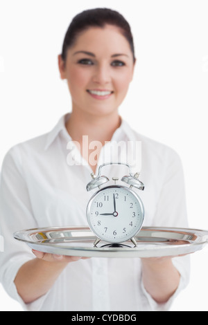 Waitress holding tray with alarm clock Stock Photo - Alamy