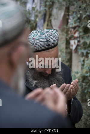 Uyghur Sufi Men Praying At Imam Asim Tomb In The Taklamakan Desert ...