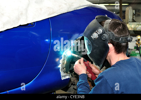 Body shop worker welding car body. Work with carbon dioxide weld Stock ...