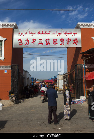 China: Uighur man outside the entrance to a mosque in Old Kuqa ...
