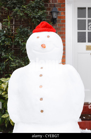 Real snowman with smile outside front door of house Stock Photo - Alamy