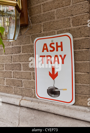 Designated smoking area sign and ash tray. Outside an office building ...