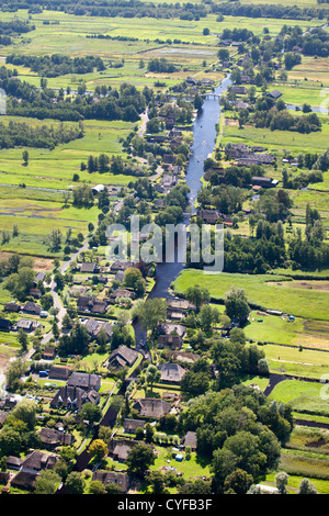 An Aerial shot of Giethoorn village with houses and green trees in a ...