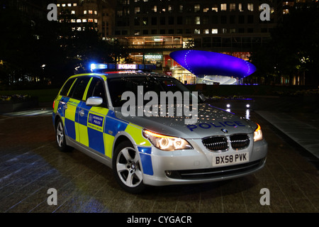 metropolitan police patrol car speeding through streets with blue ...