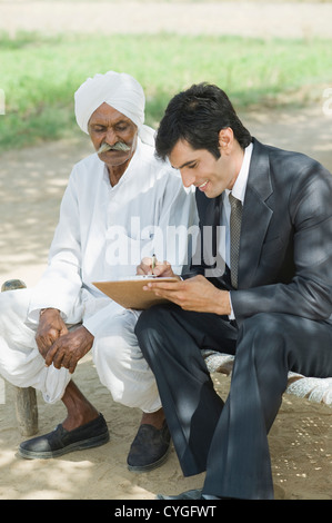Financial advisor explaining to a farmer about agriculture loan ...
