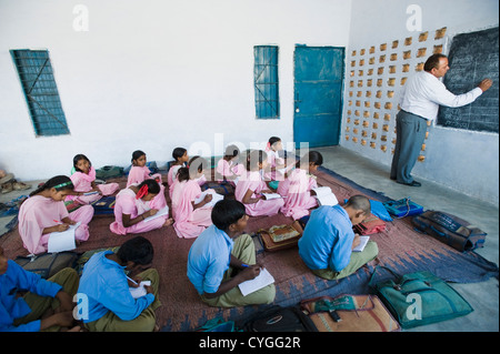 Rural Indian village school teacher and children in an outside class ...