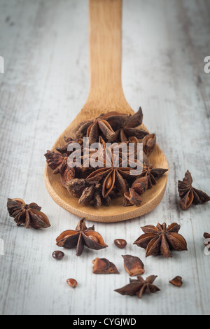 Star anise on a wooden table, closeup Stock Photo - Alamy