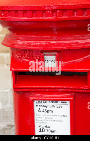 Freshly painted bright red Royal Mail post box with gold lettering ...