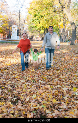 happy family walking at autumn park Stock Photo - Alamy