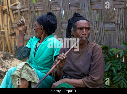 Tribal women smoking traditional pipe on the vegetable market in Ruma ...