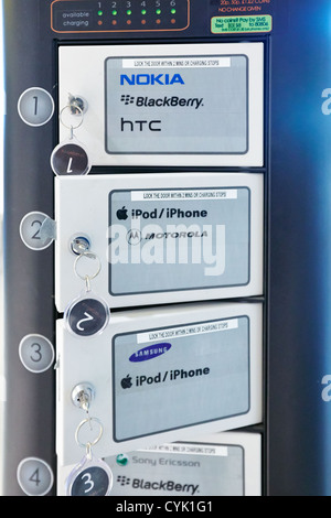 Paid-for mobile phone charging point at Gatwick Airport, London Stock ...