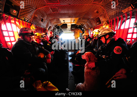 Members of Maryland Urban Search and Rescue Task Force one fly aboard a ...