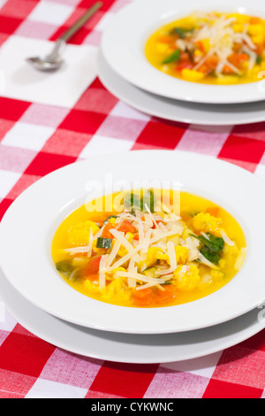 Minestrone in a plate with a spoon, close up Stock Photo - Alamy